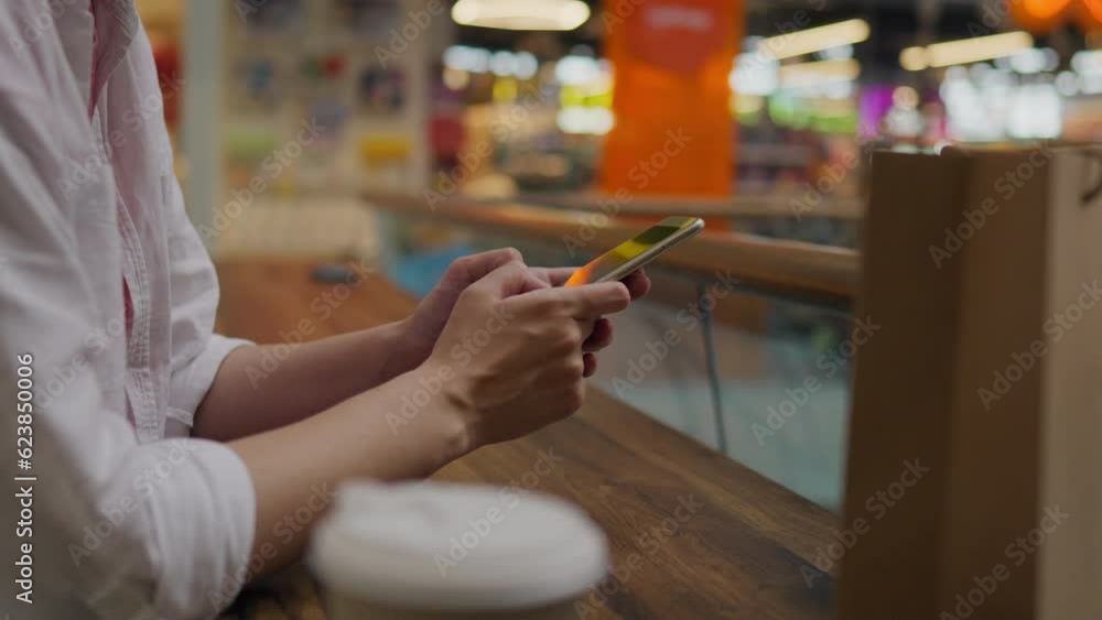 Shopping mall, Woman browsing a clothing store Holding a modern phone ...