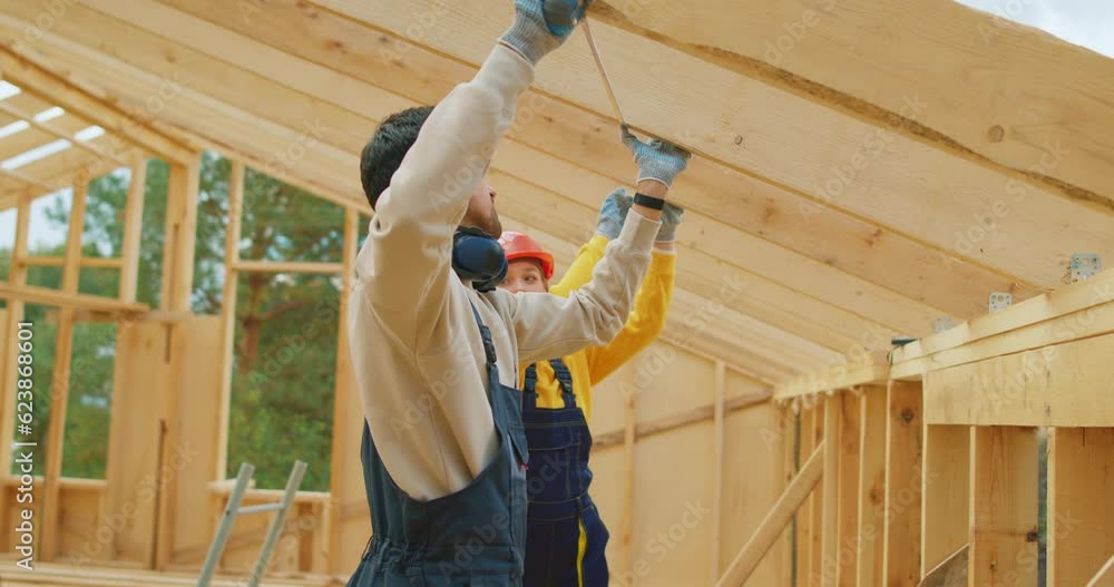 Vidéo Stock team of man and woman builders in work uniform and hardhat ...