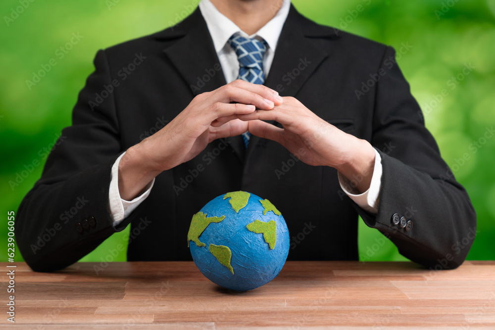 Foto de Businessman holds paper earth as symbol of eco environmental ...