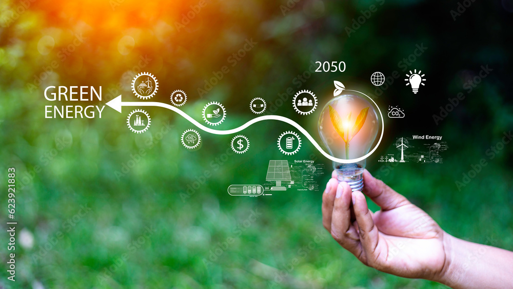 green energy system. Green tree in light bulb on grass nature ...