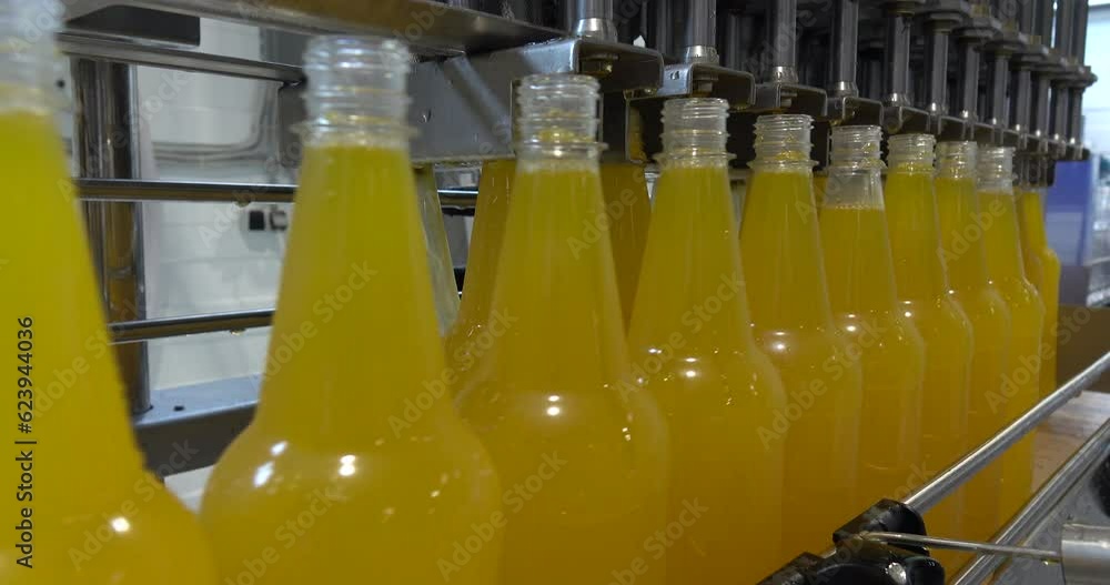 Bottling lemonade at the factory. Production of beverages - carbonated ...