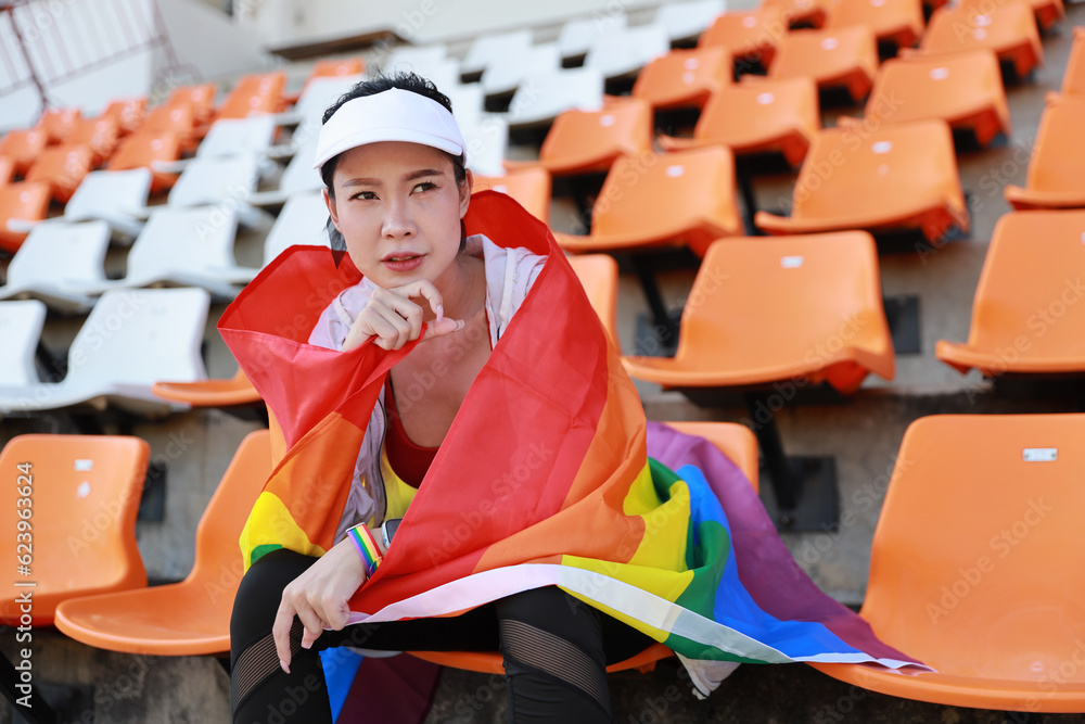 Happy and excited young female asian transgender LGBT sport fan ...