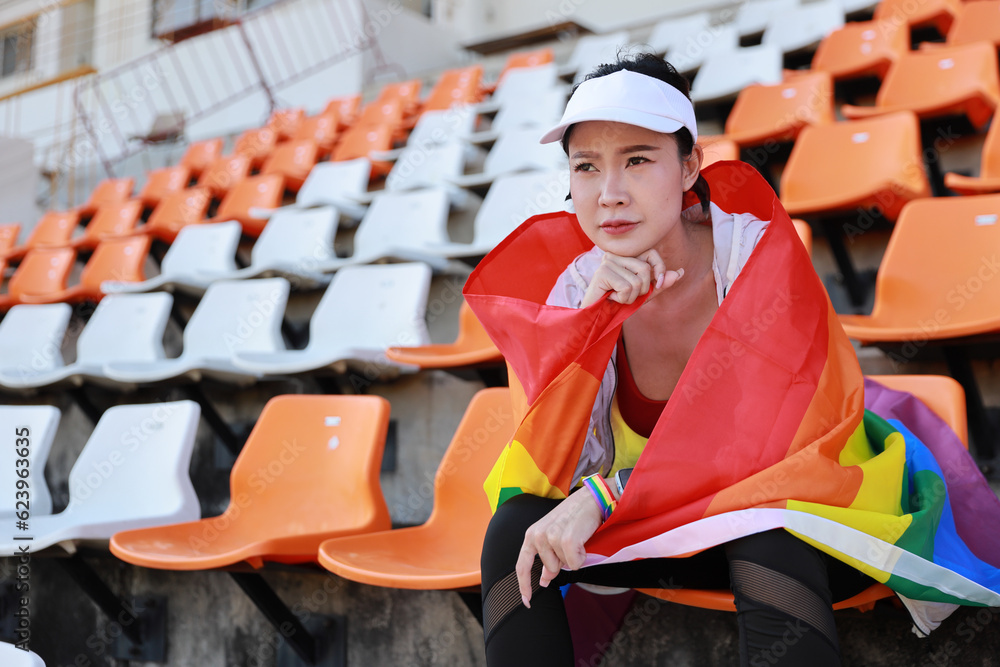 Happy and excited young female asian transgender LGBT sport fan ...