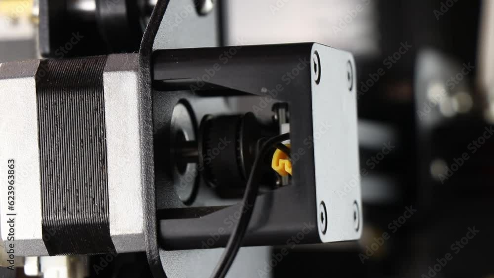Stepper motor of a 3d printer machine with the belt drive view. X axis ...