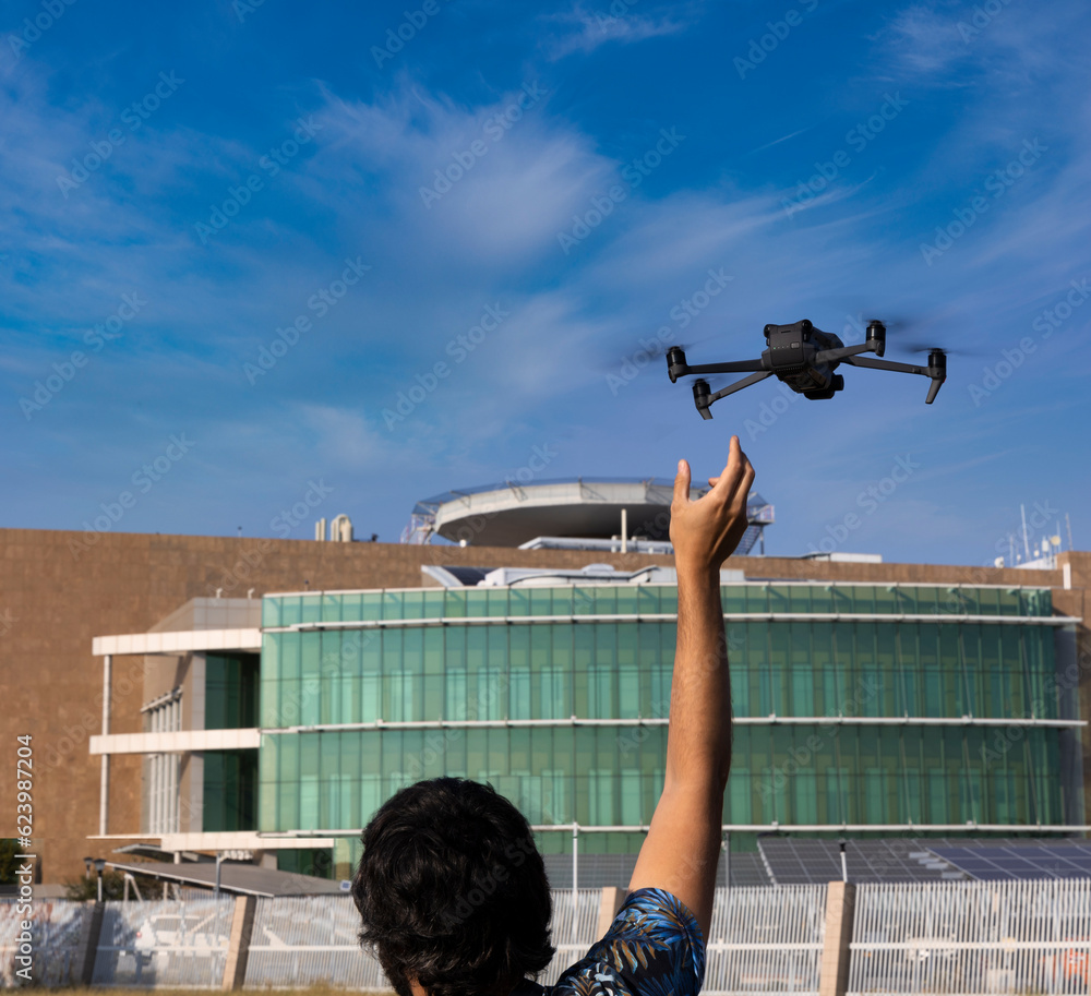 drone pilot catching the drone at landing in front of a building Stock ...
