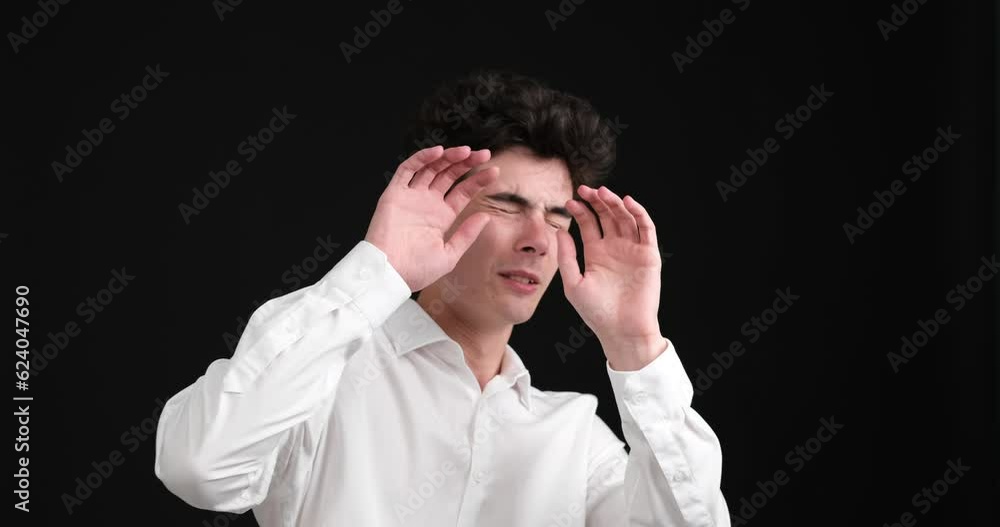 Against a black background, a young Caucasian man appears visibly ...