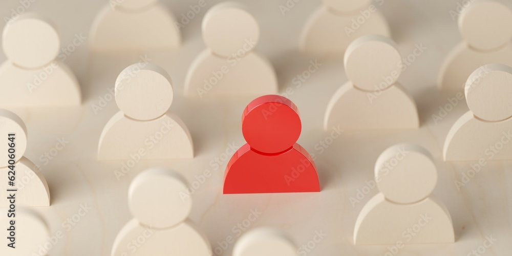 Red wooden figure standing out in group of wooden figures on table ...