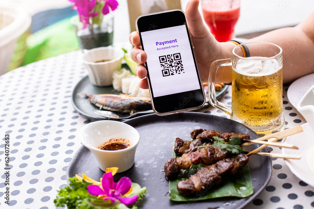 Customer hand using smart phone to scan QR code tag with beer and ...