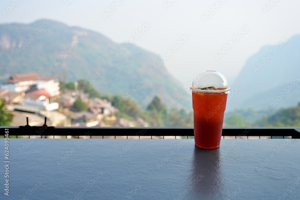 Iced lemon tea or Iced tea without milk placed on a wooden table. A ...