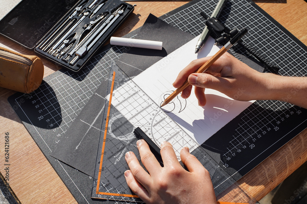 Architect and designer working accurately on a project drawing sketches ...