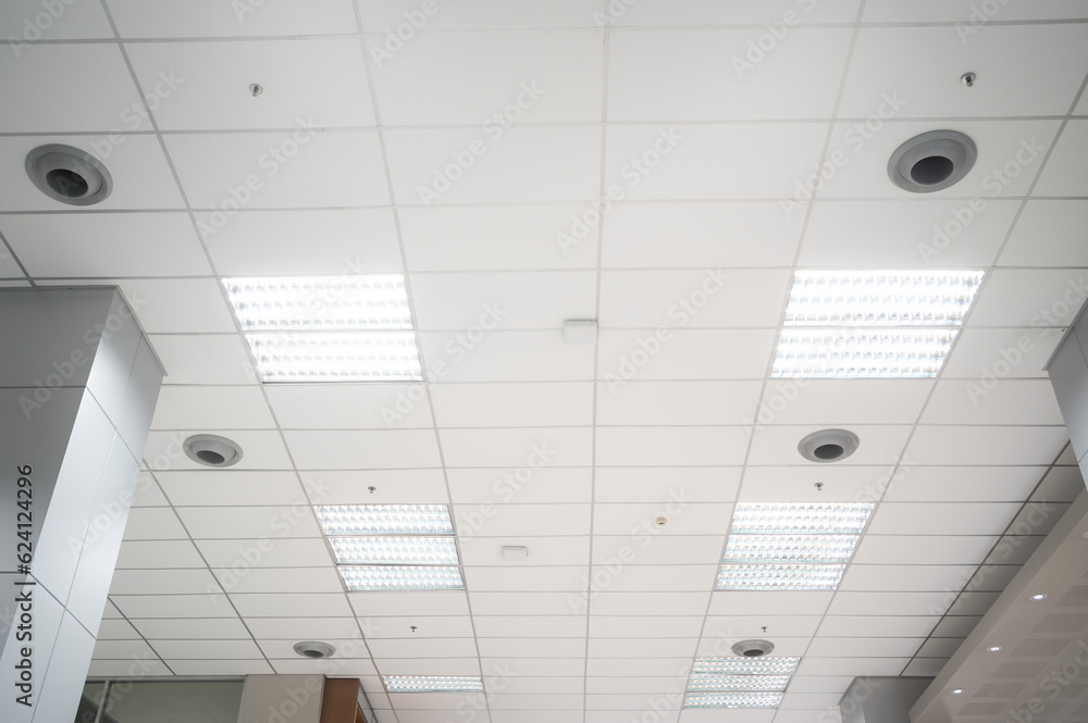 Ceiling mounted cassette type air conditioner and modern lamp light on ...