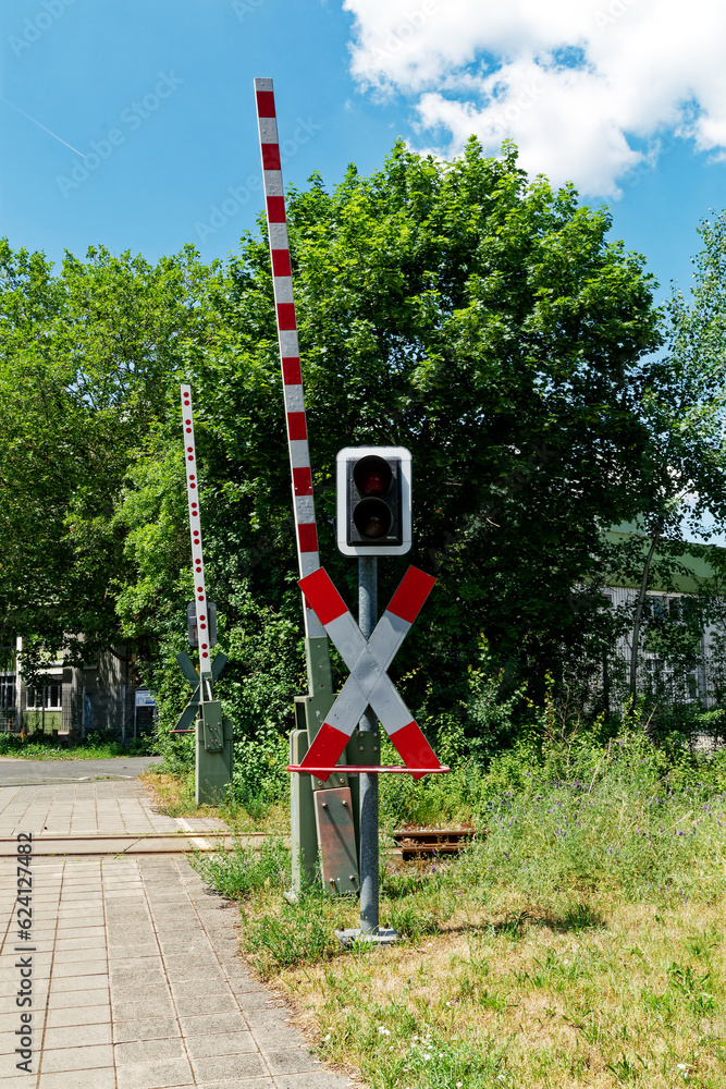 Level crossing with barriers, traffic lights and St. Andrew's cross ...