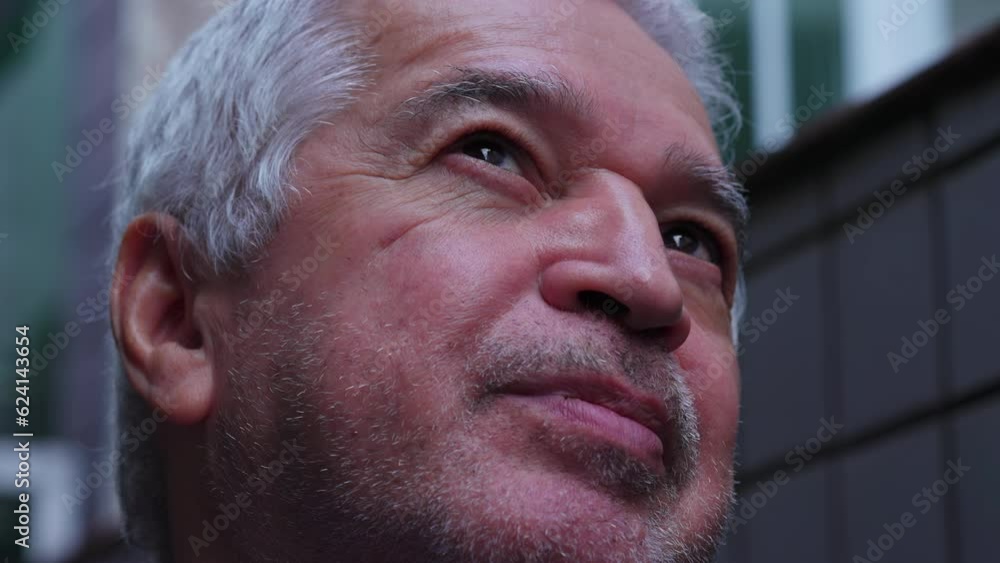 Close-up face of a senior man looking up at sky with HOPE and FAITH ...