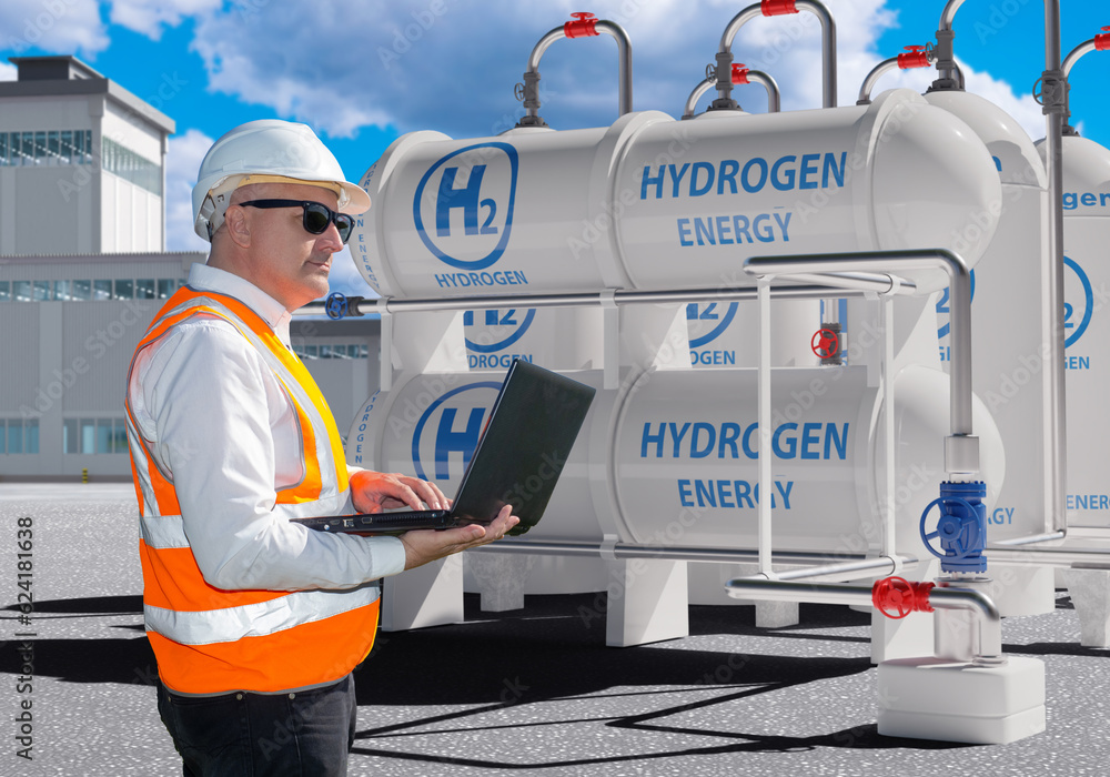 Hydrogen energy. Man with laptop near factory. Hydrogen plant ...