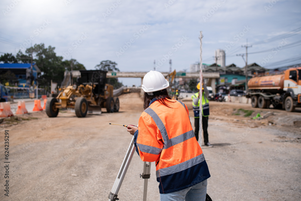 Surveyor engineers wearing safety uniform ,helmet and radio ...