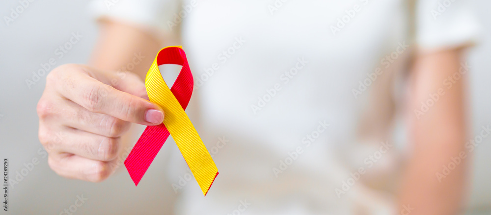 woman holding Red and Yellow ribbon. World hepatitis day awareness ...