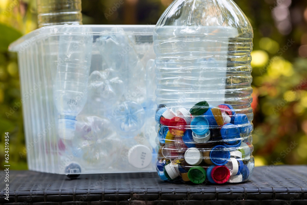 A container made of plastic bottles and plastic lids. Garbage ...