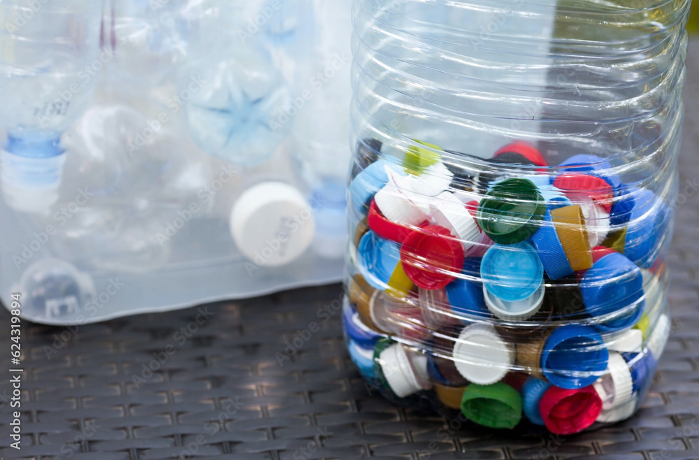 A container made of plastic bottles and plastic lids. Garbage ...