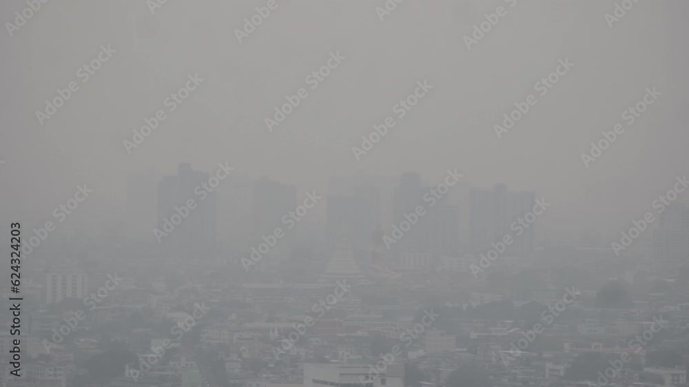 The cityscape of Bangkok is obscured by a thick blanket of dust and ...