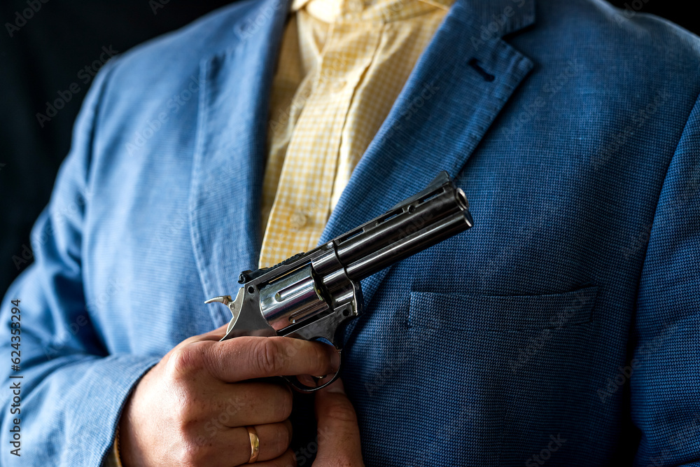 Sniper man in black suit gesturing and boldly holding gun on isolated ...
