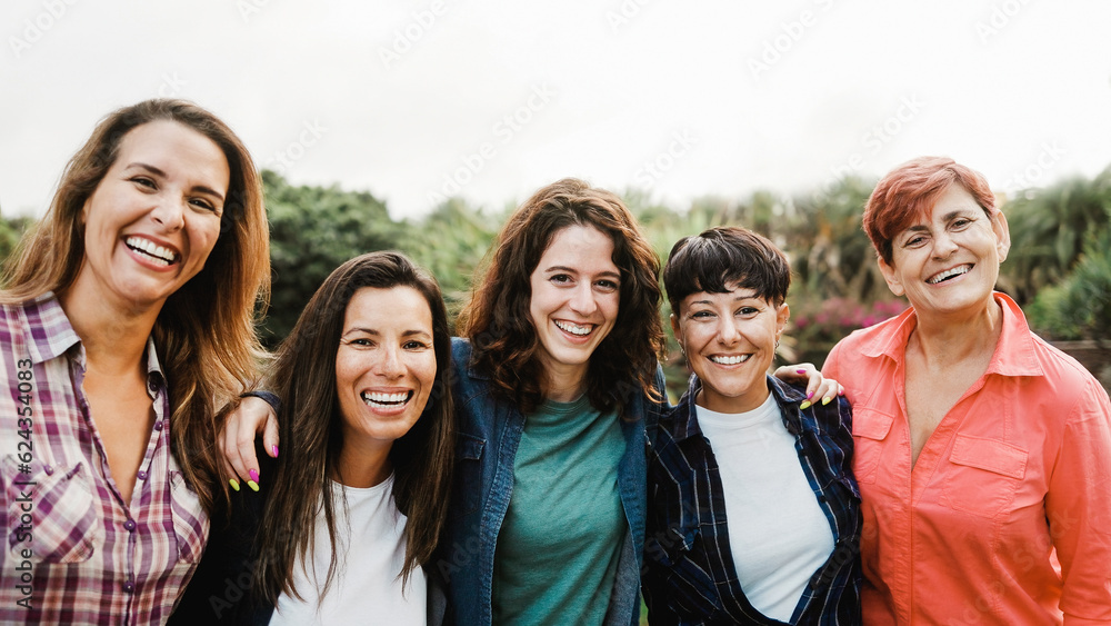 Multi-generational group of women hugging each outside park city ...