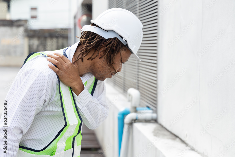 Overworked and injured Male African engineer worker having shoulder ...
