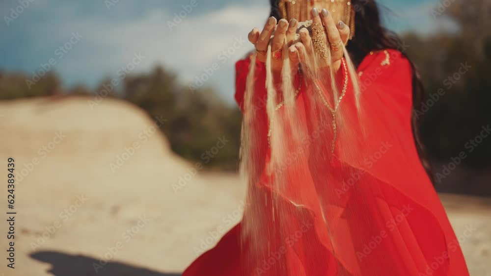 Arabian woman hands touching holding sand desert beauty face hidden by facekini gold mask veil ...