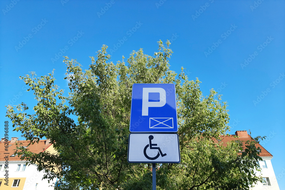 Parking only for disabled drivers. Road sign against background of tree ...