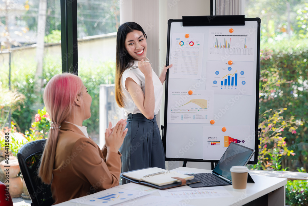 Businesswoman standing and showing joy after finishing presentation ...