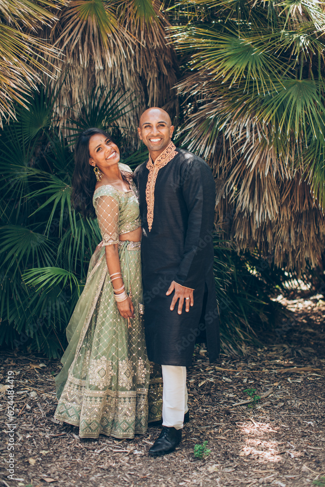 beautiful indian couple smiling with a bindi and traditional sari dress ...