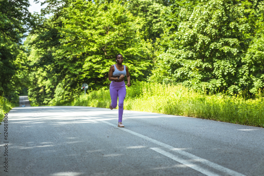 One african american female athlete looking focused while out for run ...
