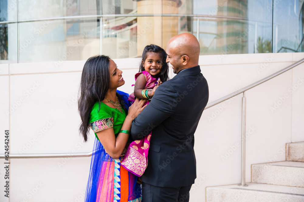 beautiful indian family with daughter girl hugging and smiling with a ...