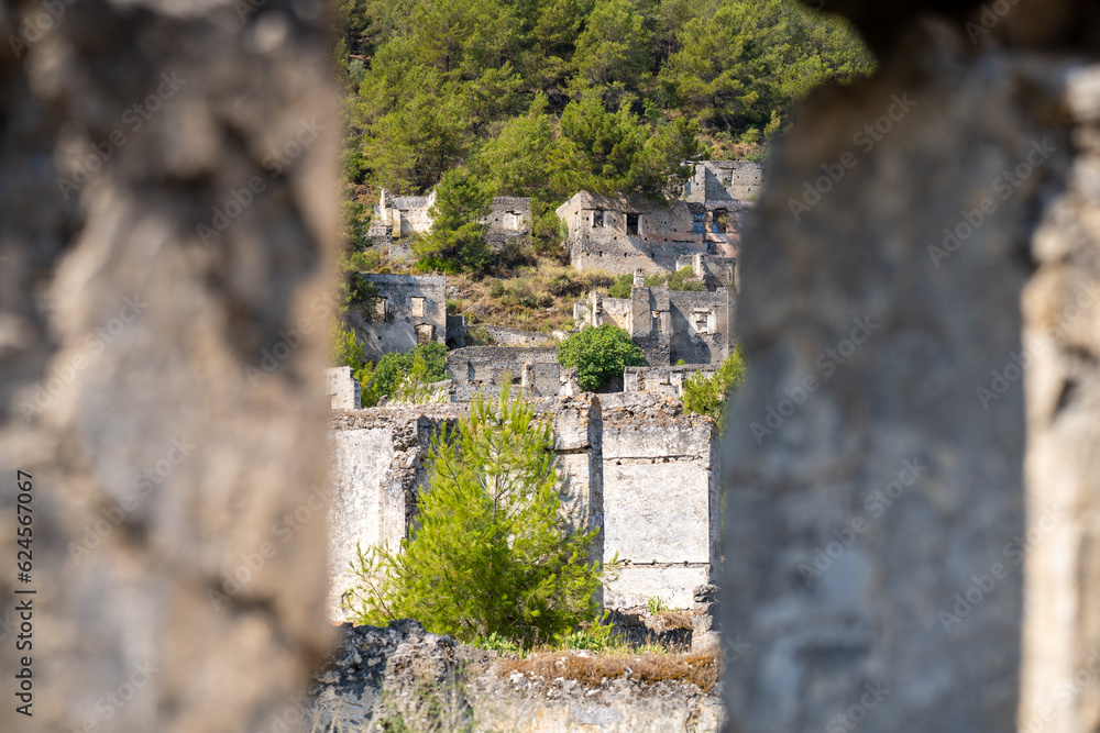 Window view of ancient Greek house ruins in the ghost town of Kayakoy ...