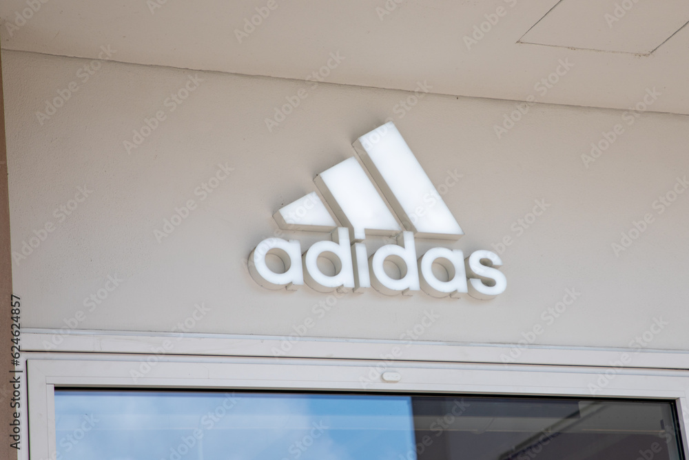 adidas logo sign and brand text front of facade entrance sporty shop ...