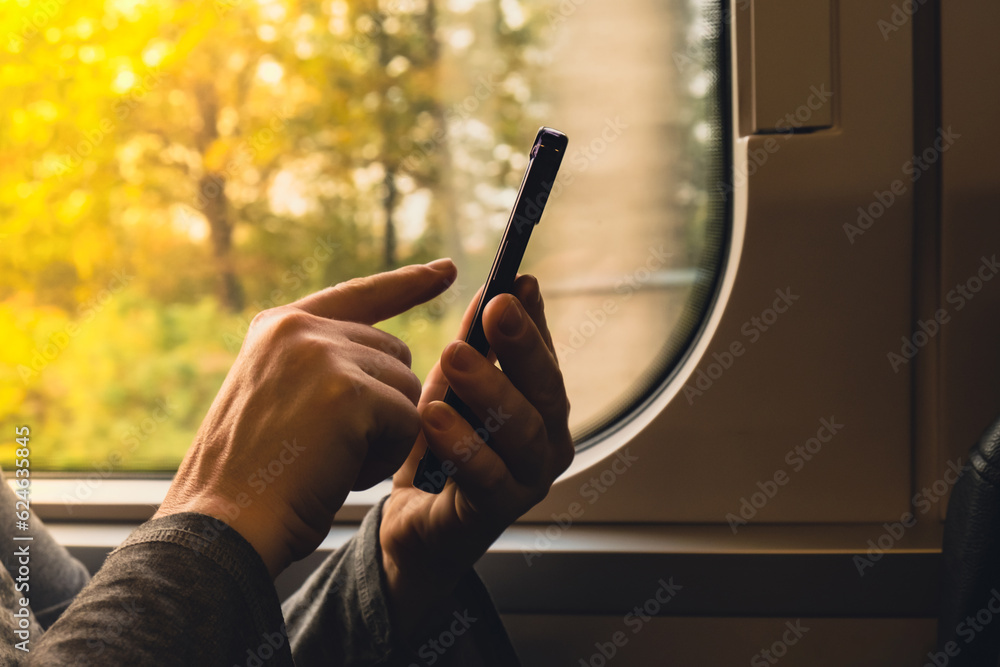 Close-up shot of woman's hands tapping on mobile phone screen Female traveler in high speed ...