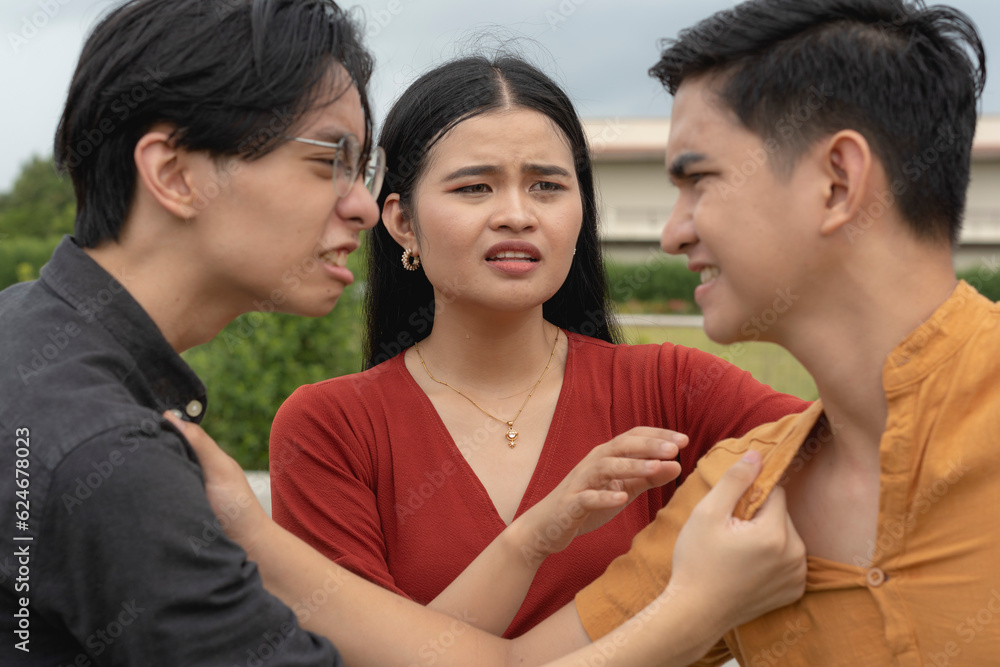 A young asian lady gets in between two rival male suitors to stop them ...