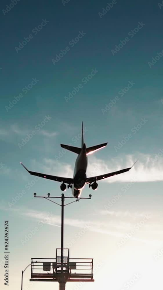 Jet plane landing in silhouette. Tracking shot of airplane landing at ... Jet plane landing in silhouette. Tracking shot of airplane landing at ...