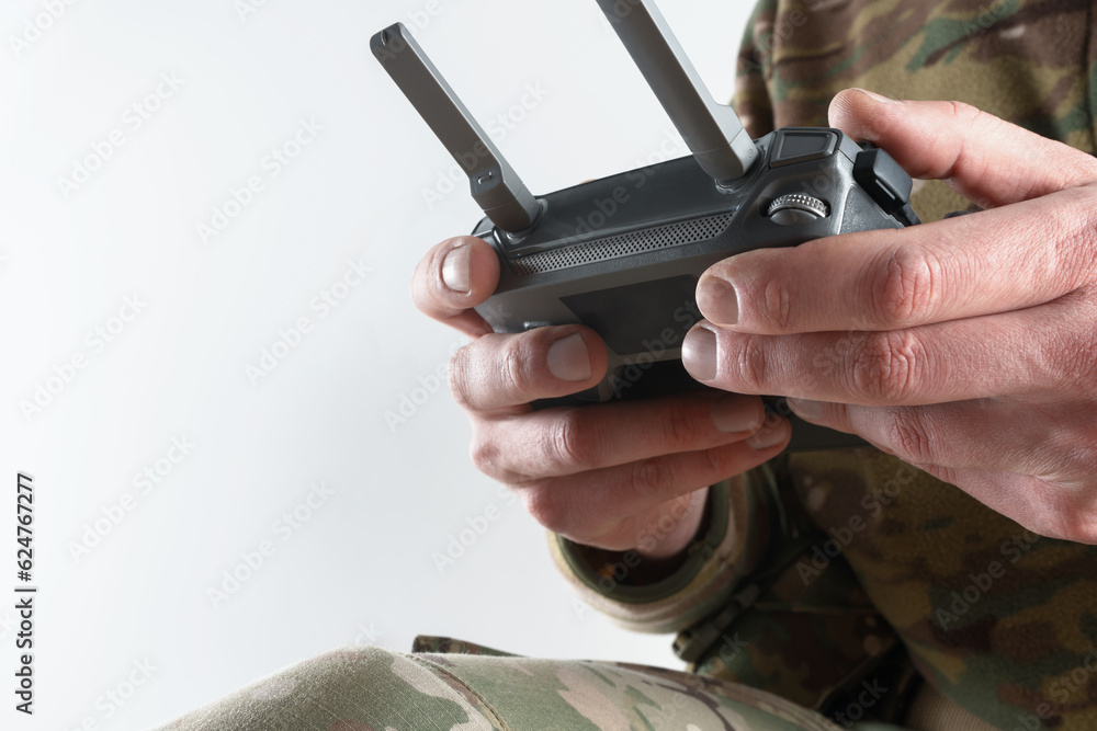 Soldier in military uniform holding drone remote control close-up ...