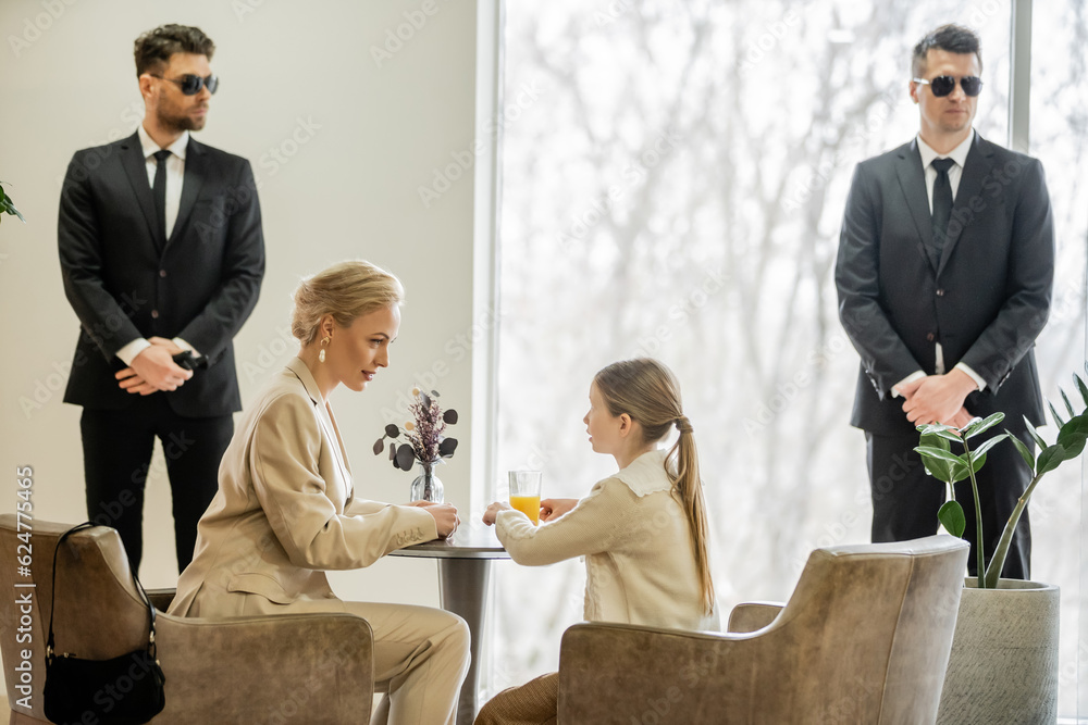 private security concept, bodyguards standing near female clients ...