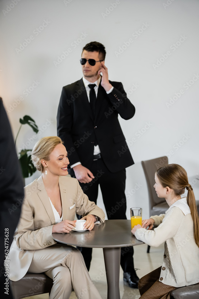 private security concept, successful happy mother and daughter spending ...