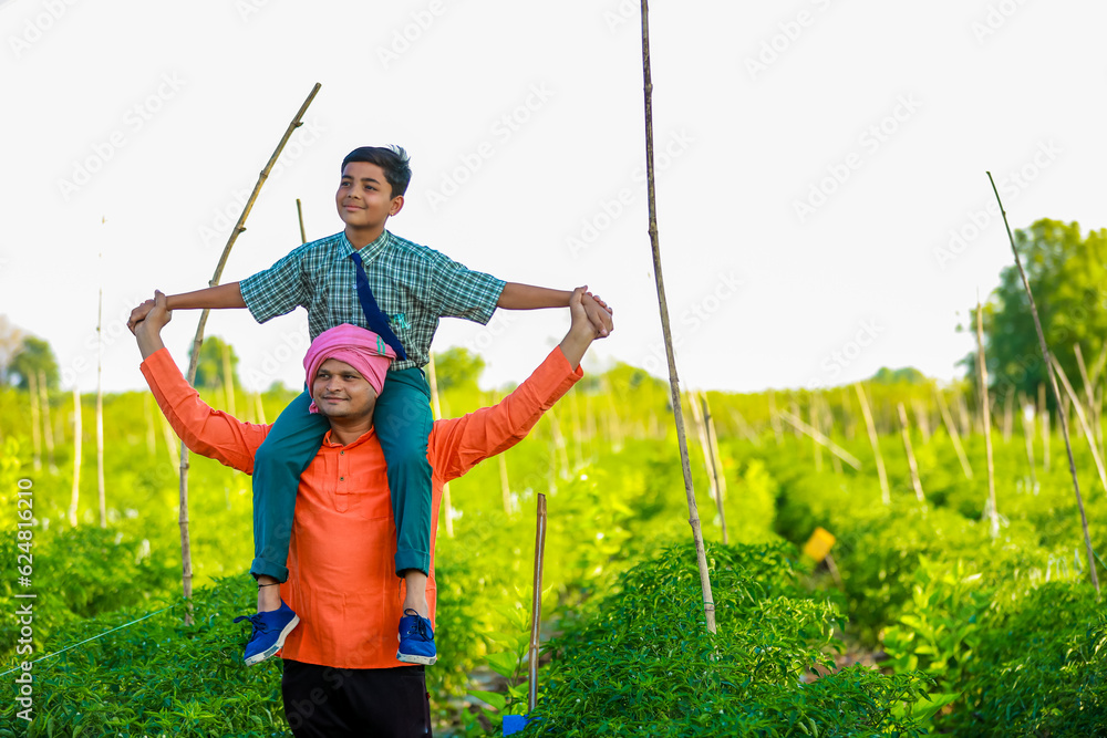 Cute indian farmer child in school uniform with his father at ...