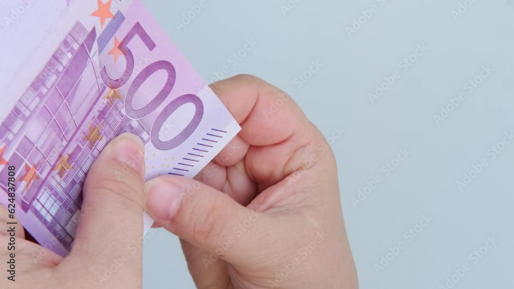 checking euro bills for authenticity, female hands determines touch ...