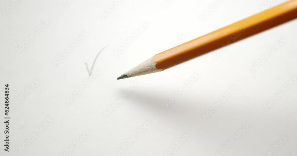 Drawing a check mark on white paper with yellow school pencil. Stock ...