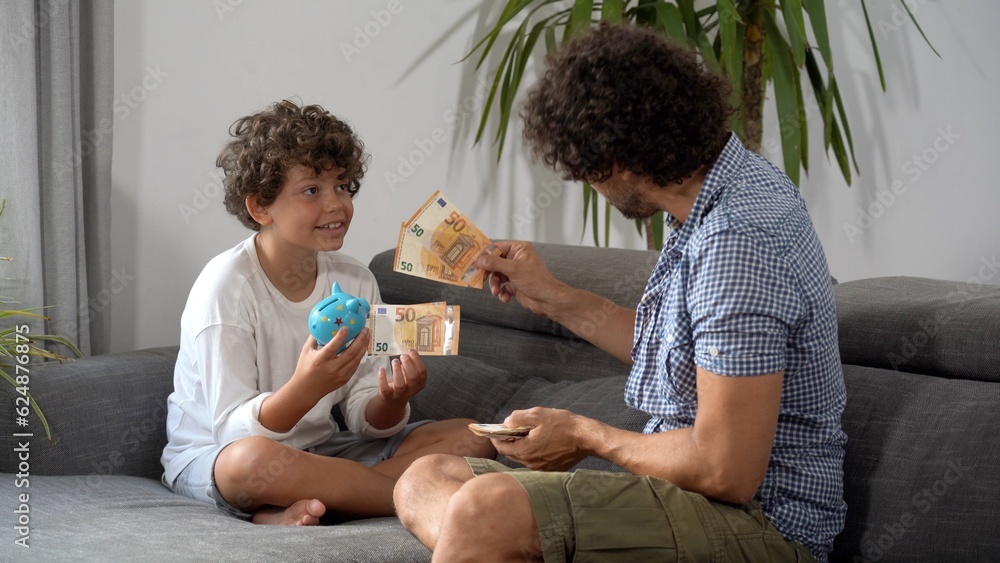 Father and son boy 9 years old - sitting on sofa at home ion living ...