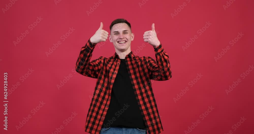 On the vibrant red background, a smiling Caucasian man raises his hand ...