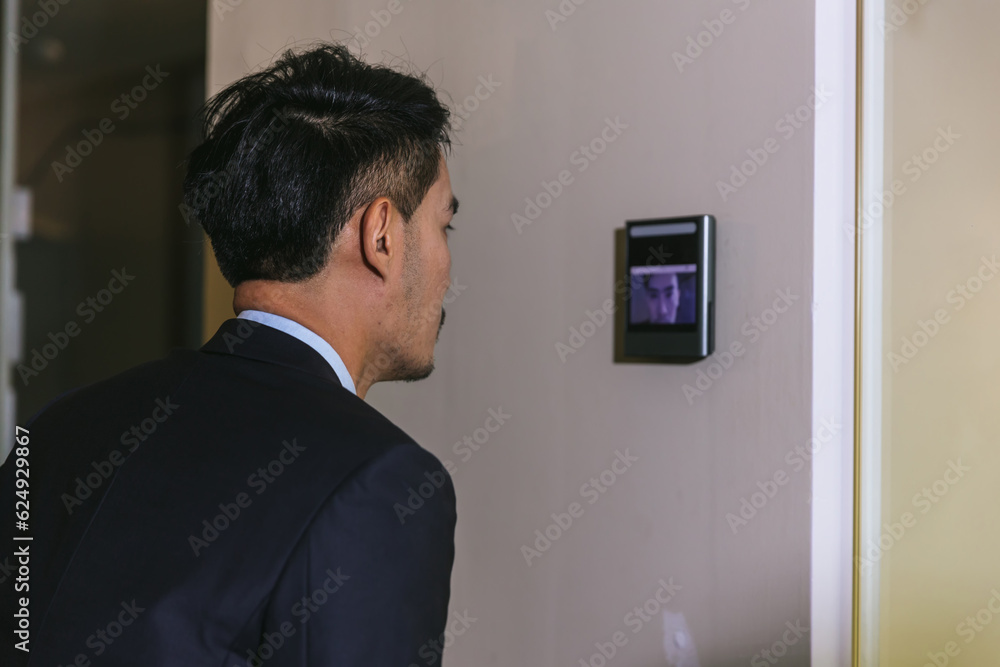 Man using face scanner to unlock door in office building. Access ...