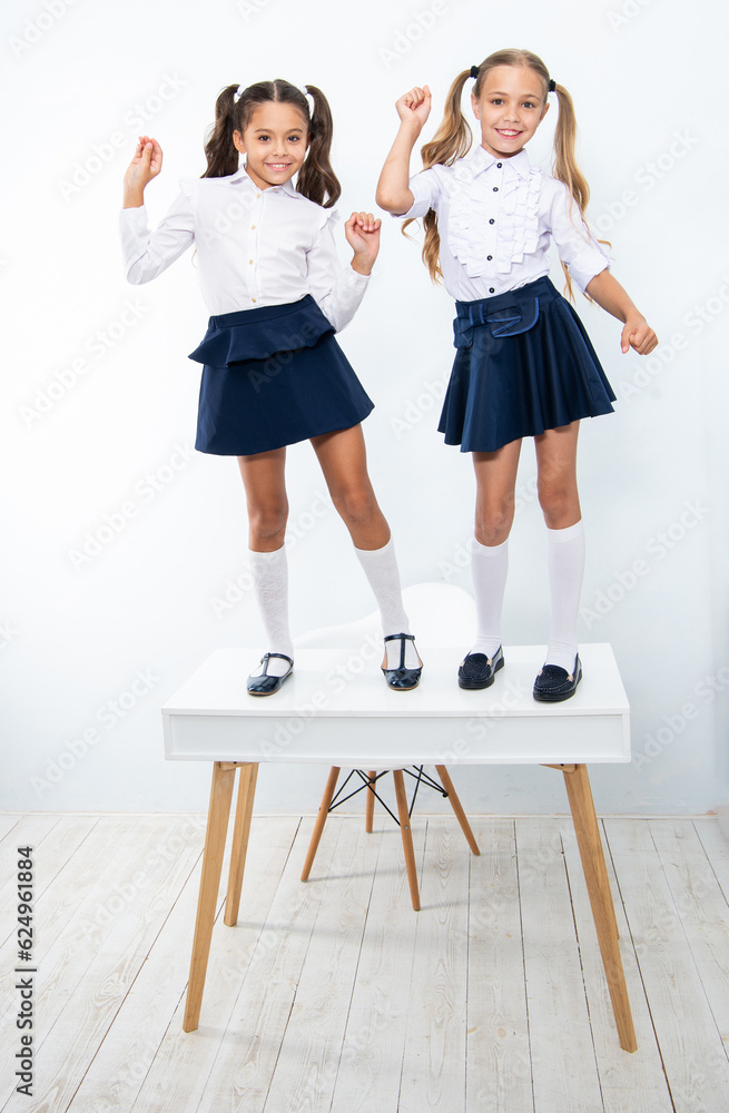 two girls in school uniform. education and knowledge. children girls ...