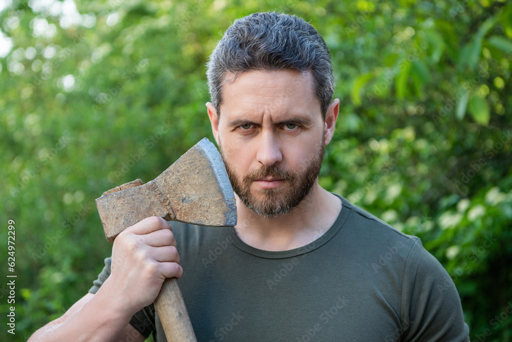 face of masculine guy with axe outdoor. photo of masculine guy with axe ...