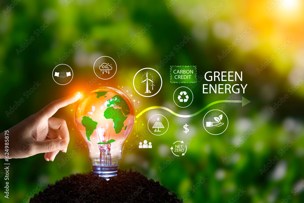 Green energy system. Businessman pointing light bulb on green ...