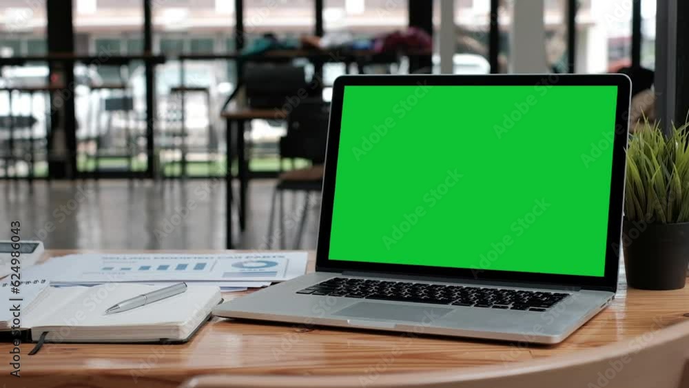 Chroma key green screen laptop computer set up for work on a office ...